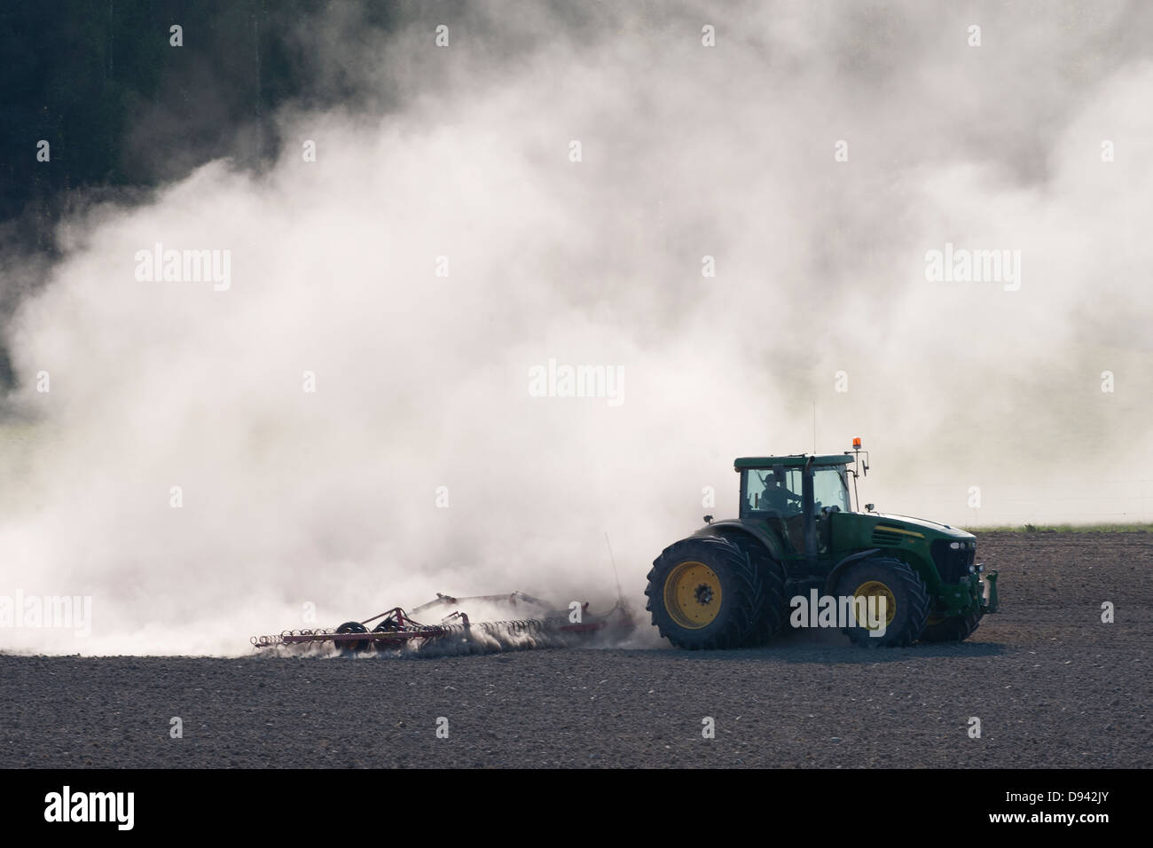 Tractor and dust on field Stock Photo - Alamy