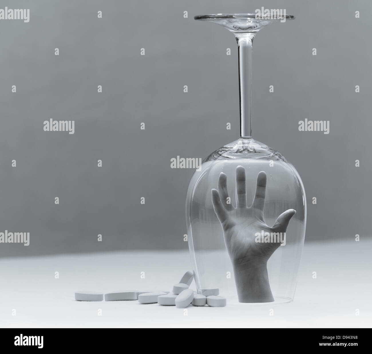 Addiction motif - A male Hand is Trapped under Glass Stock Photo - Alamy