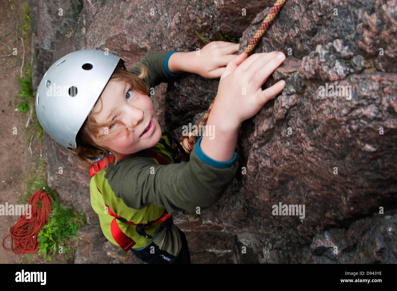 Boy climbing on rock Stock Photo - Alamy
