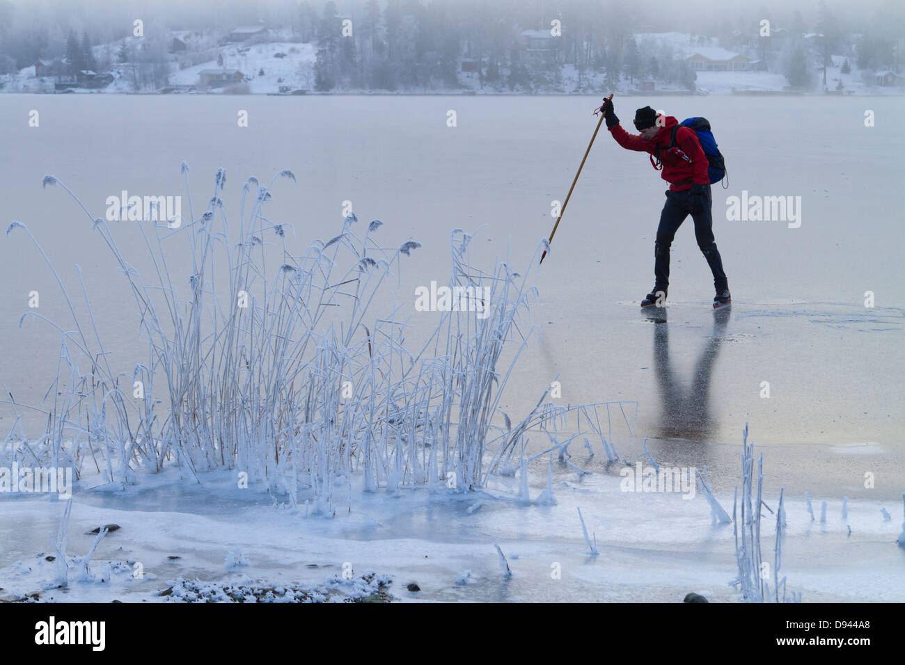 Man ice-skating of frozen lake Stock Photo - Alamy
