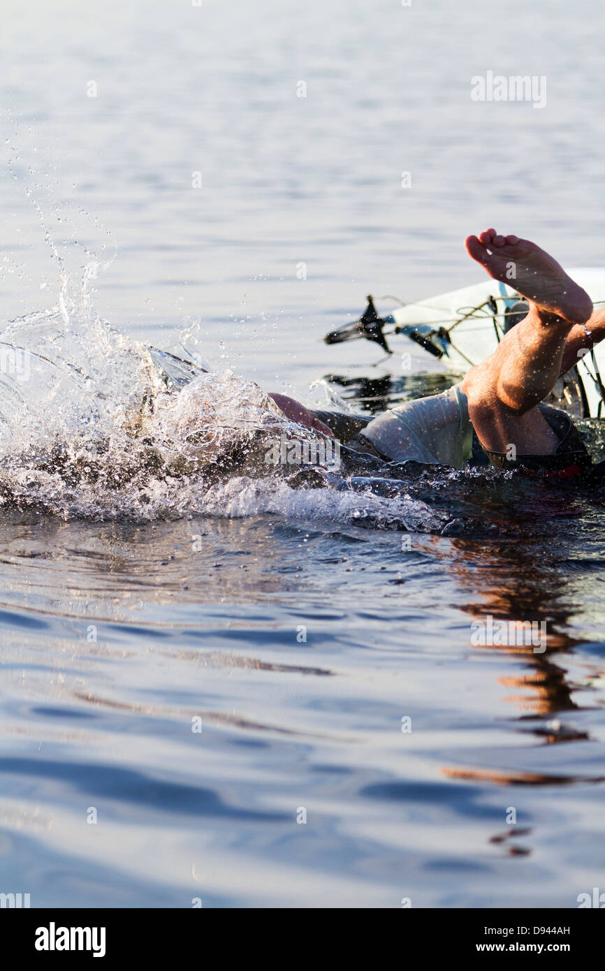 Man falling from canoe into cold lake Stock Photo - Alamy
