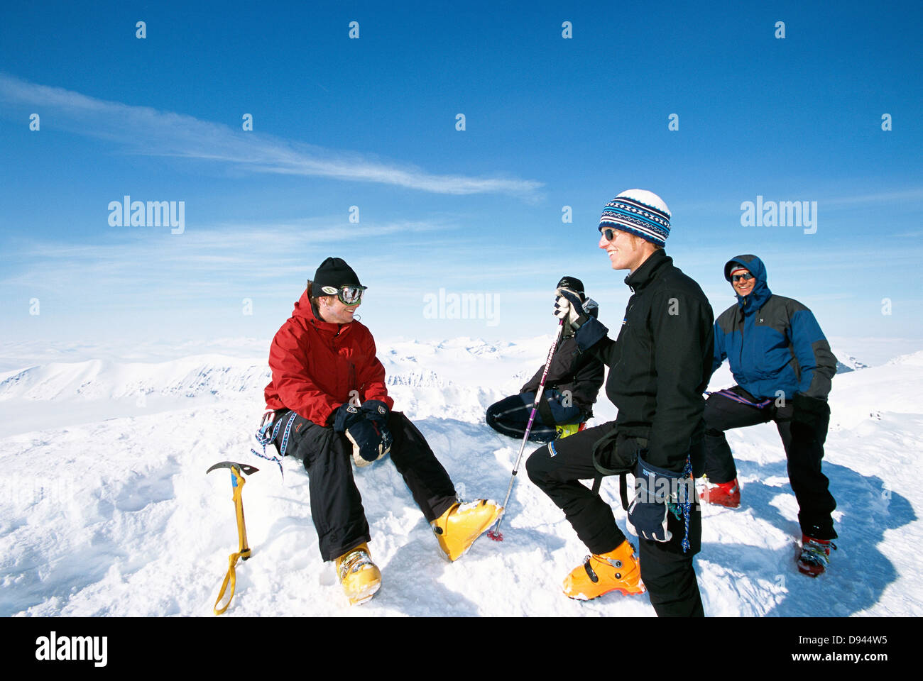 Four skiers on the top of the mountain Stock Photo - Alamy
