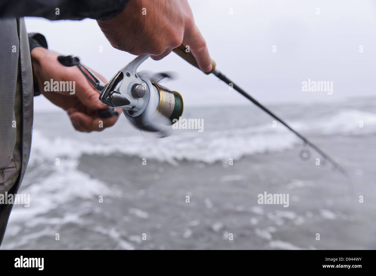 Hands holding fishing rod Stock Photo - Alamy