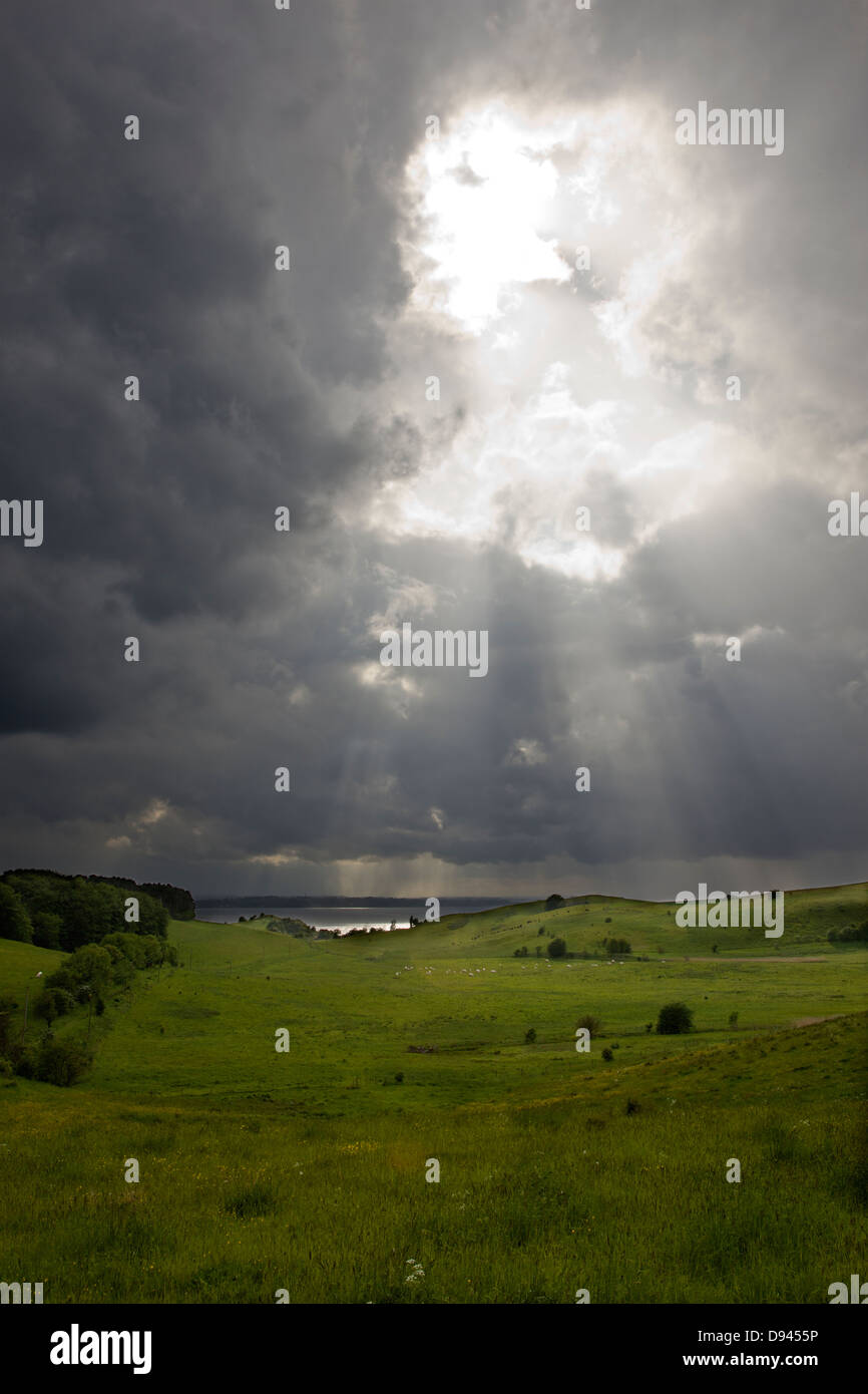 Sunbeams breaking through storm clouds Stock Photo - Alamy
