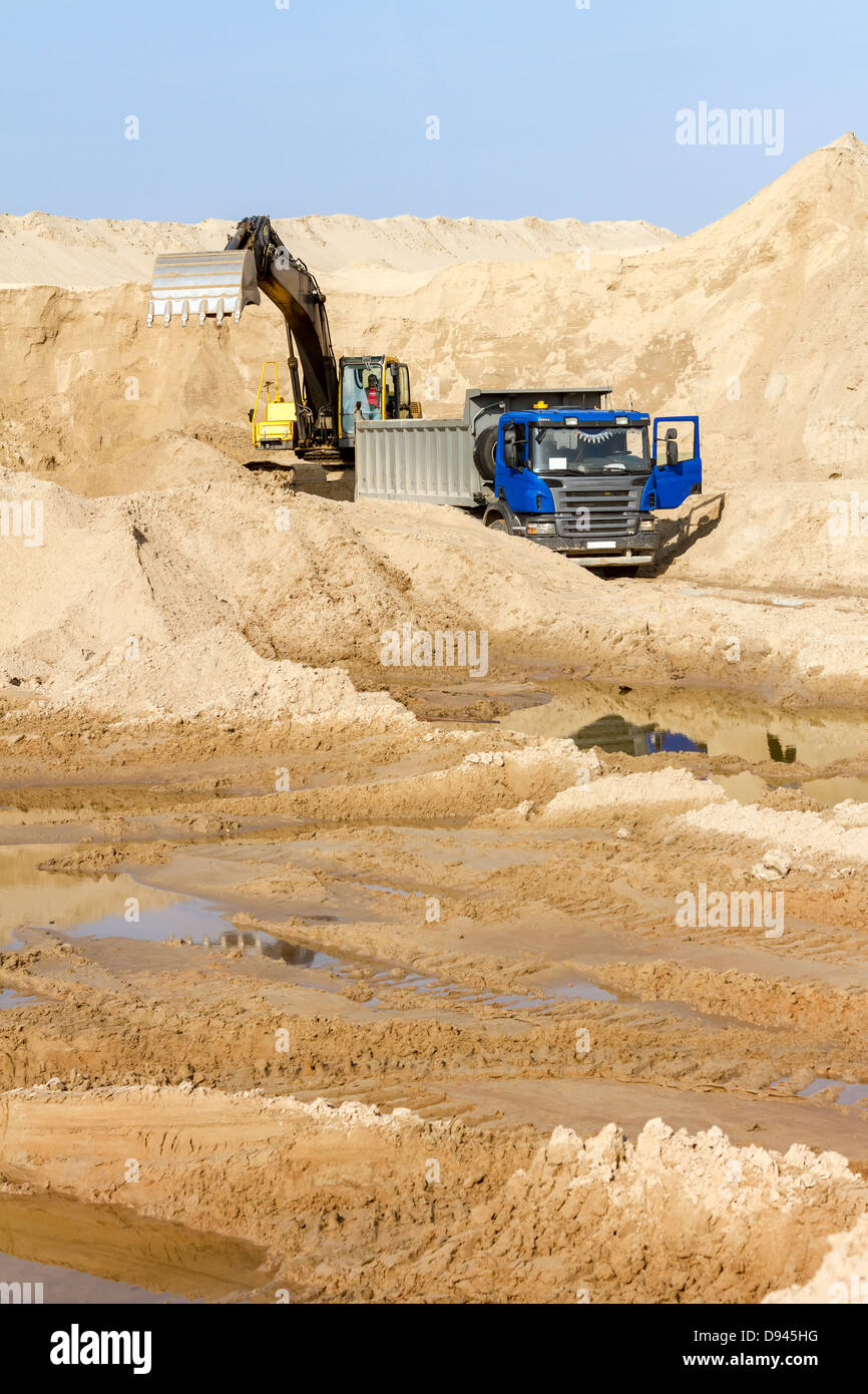 Working Yellow Excavator at Construction Site Stock Photo - Alamy