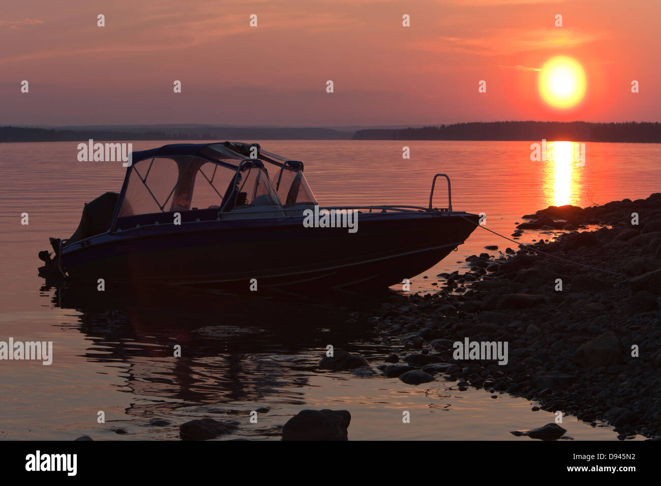 Boat at sunset Stock Photo - Alamy
