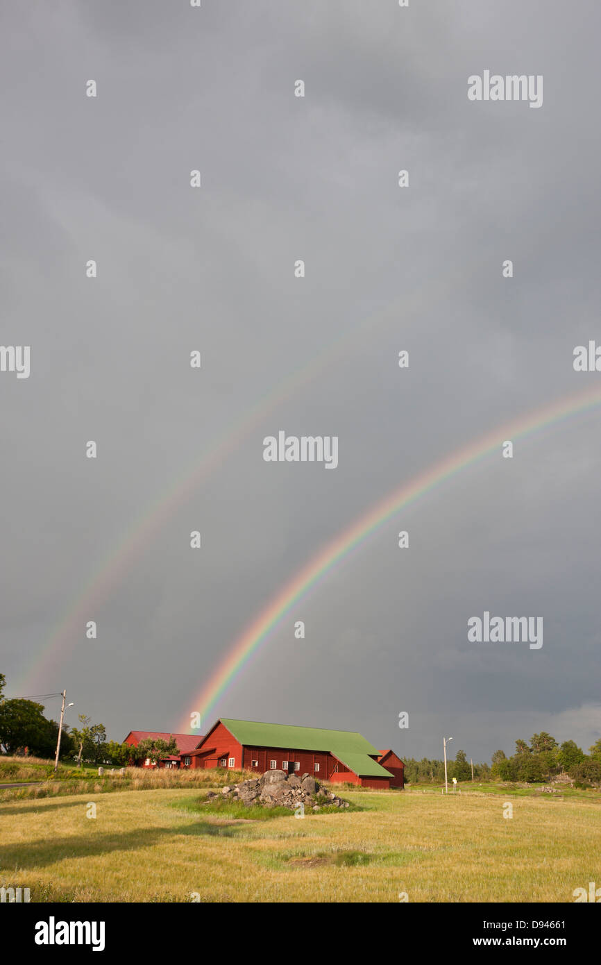 Rainbow over wooden barn Stock Photo - Alamy