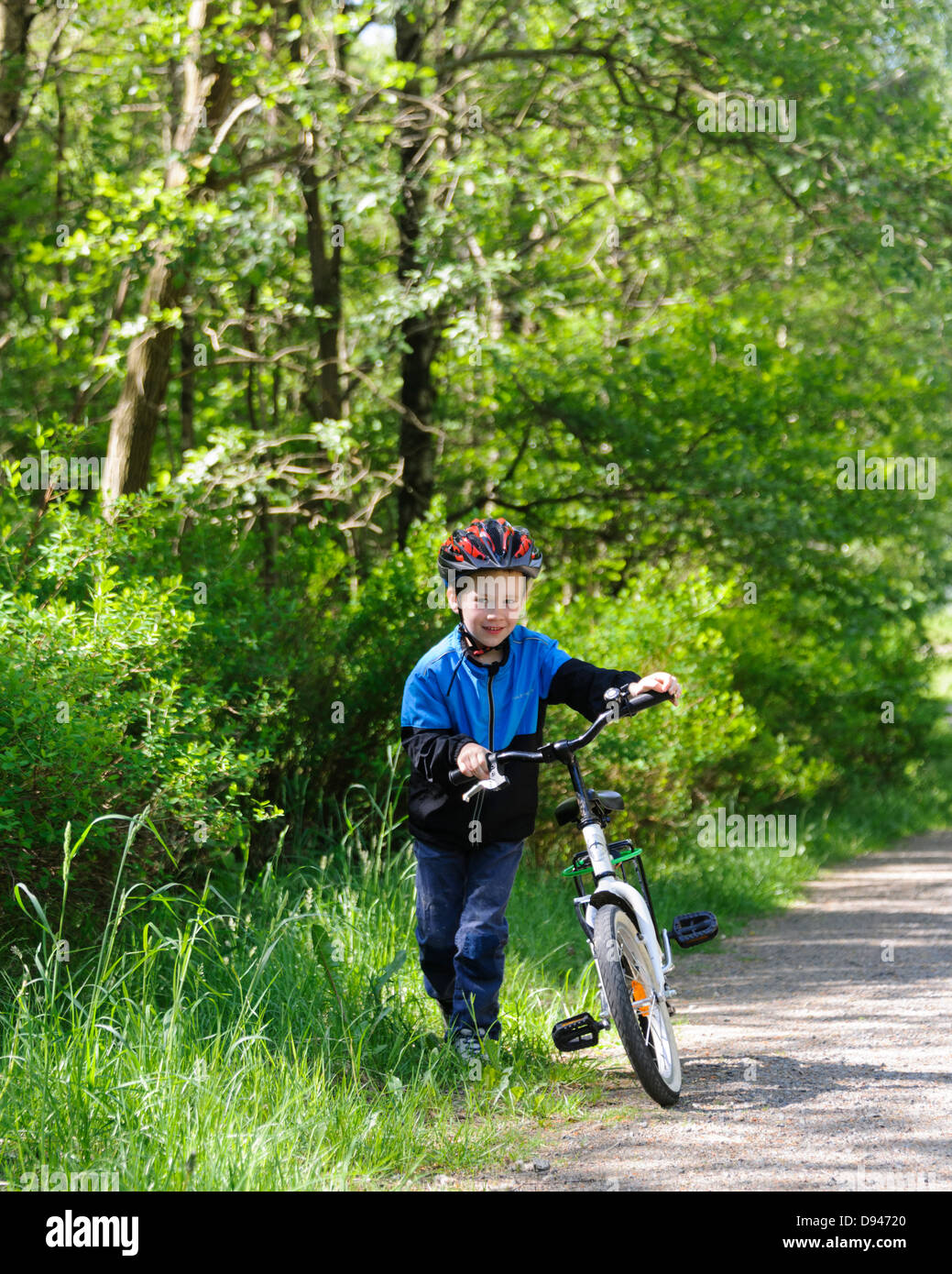 Smiling boy with bike Stock Photo - Alamy