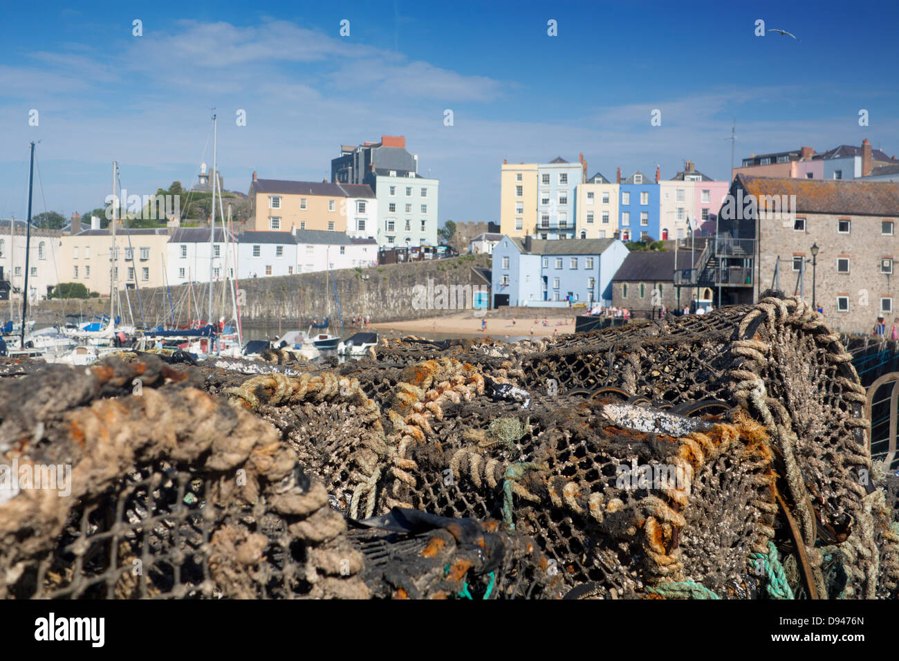 Tenby Harbour lobster pots in foreground Boats and Georgian terraced ...