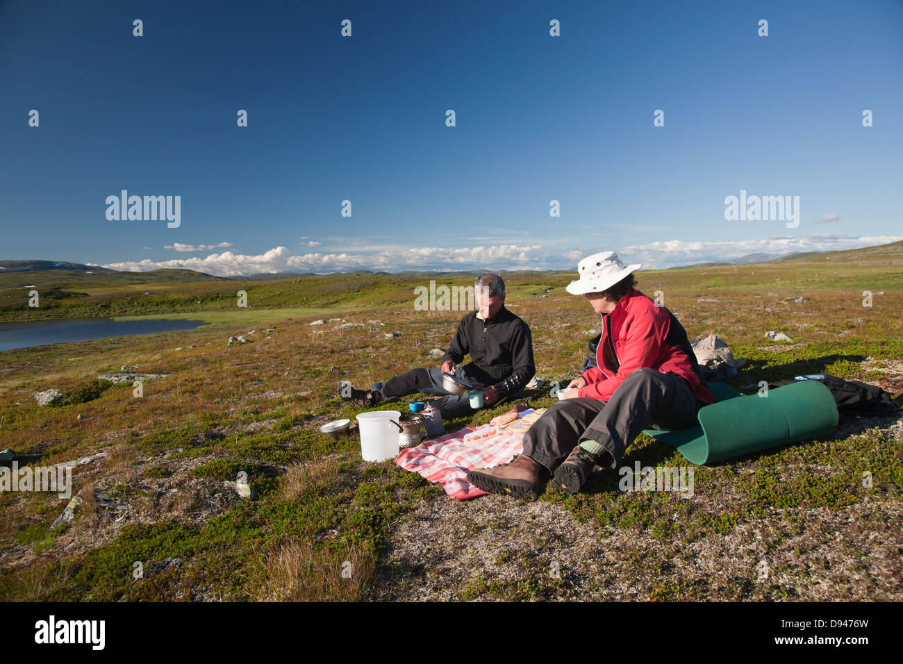 Couple having break during hiking Stock Photo - Alamy