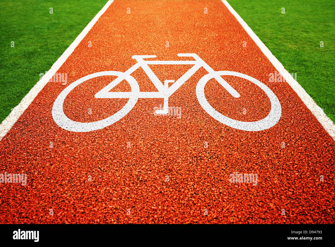 Bicycle lane mark. White sign for bicycle track surrounded by grass in ...