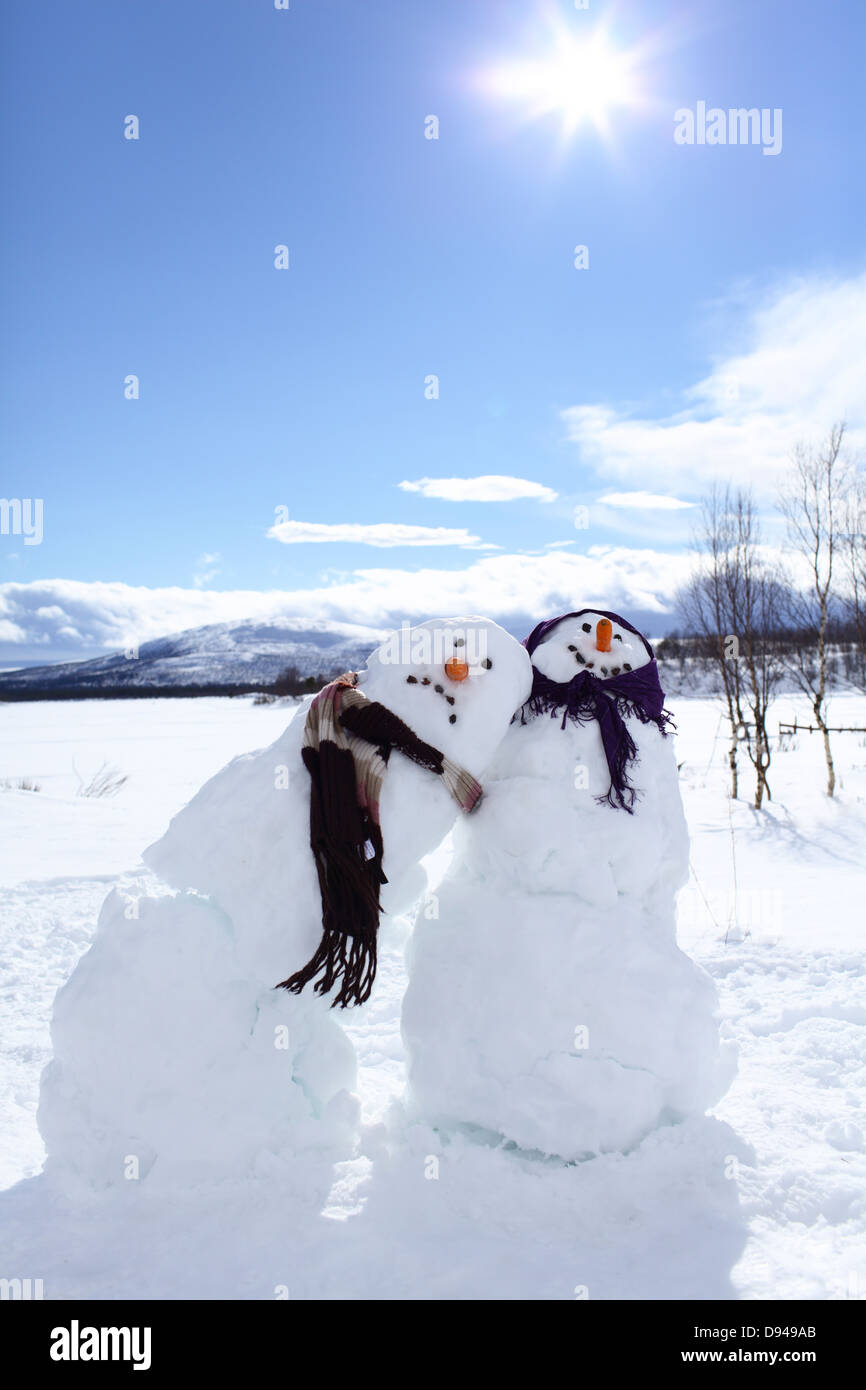 Happy snowman and sad snowman standing together Stock Photo - Alamy