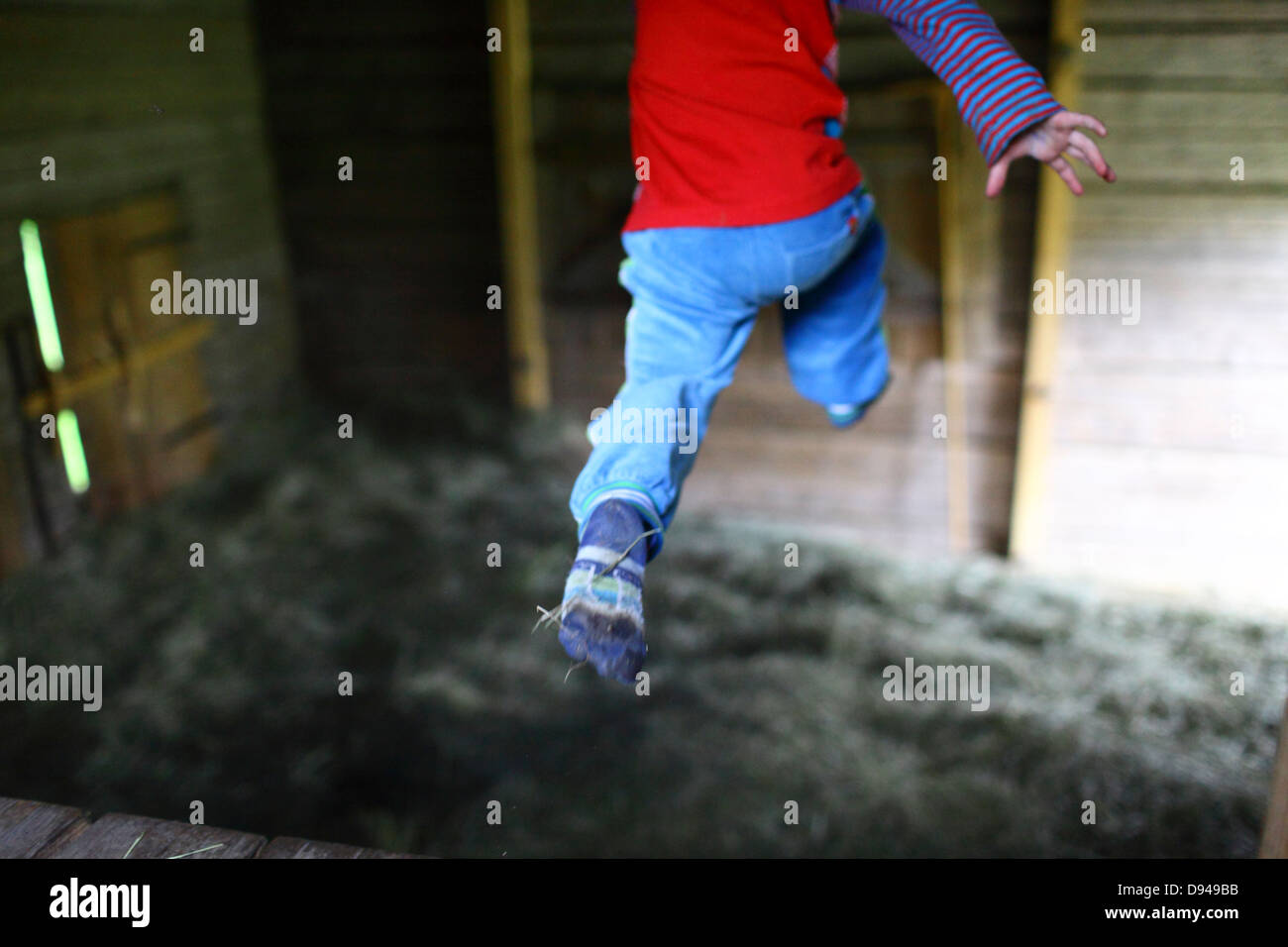 Child jumping on hay in hi-res stock photography and images - Alamy