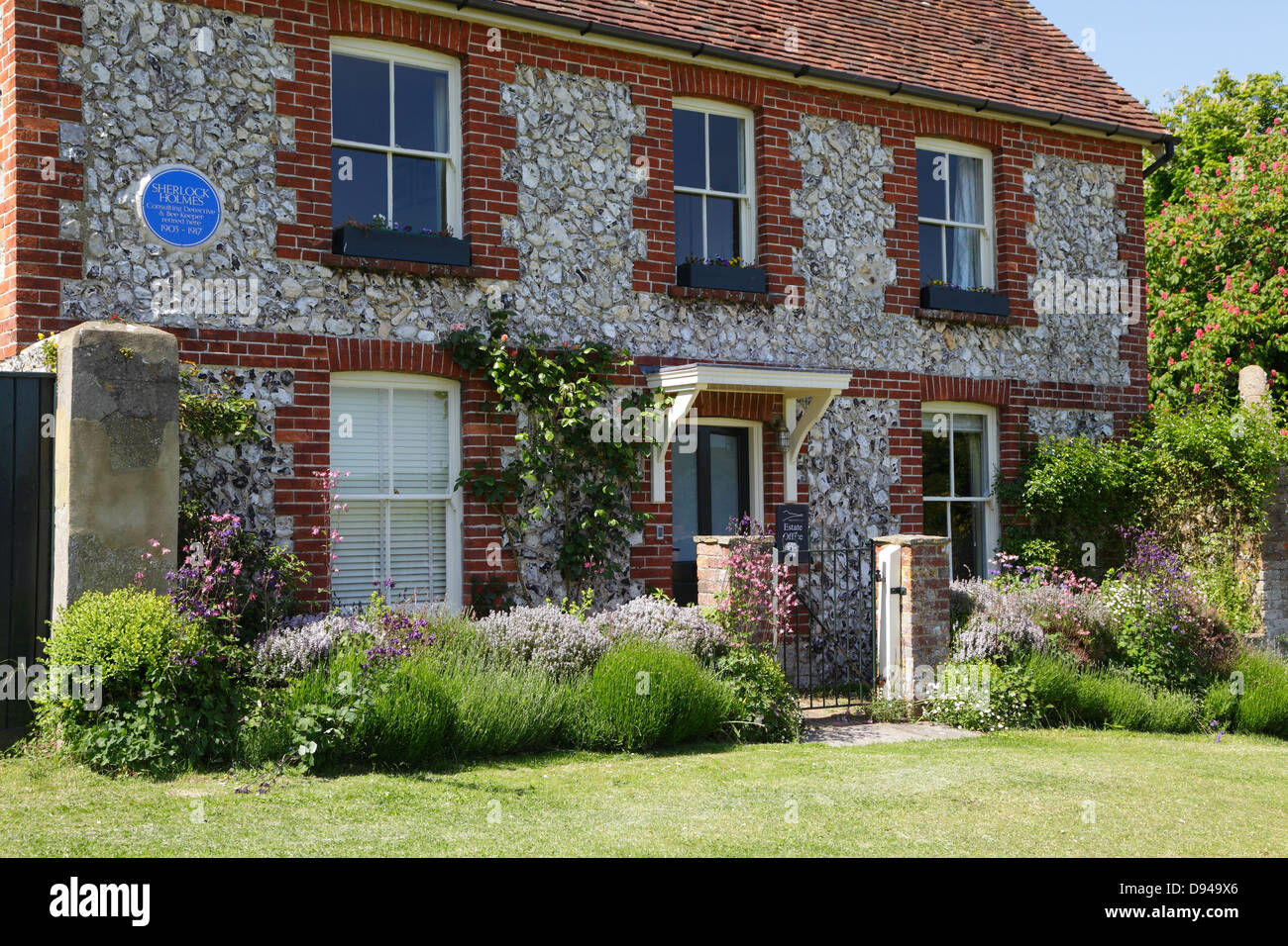Blue plaque on flint cottage at East Dean, East Sussex , where ...