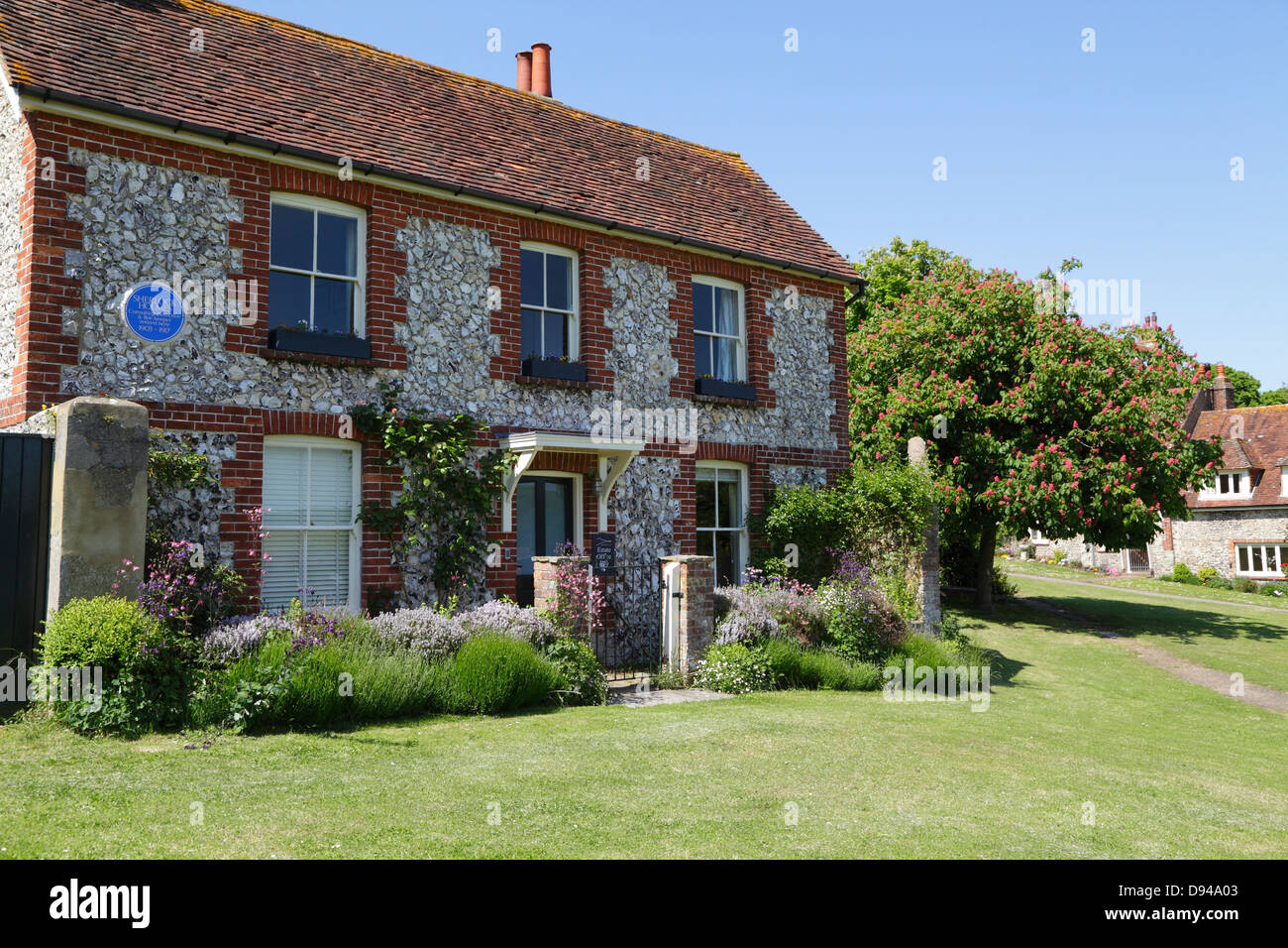 Blue plaque on flint cottage at East Dean, East Sussex , where ...