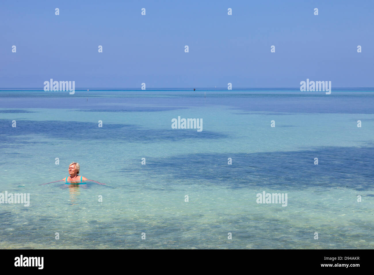 Woman swimming in tropical lagoon Stock Photo - Alamy