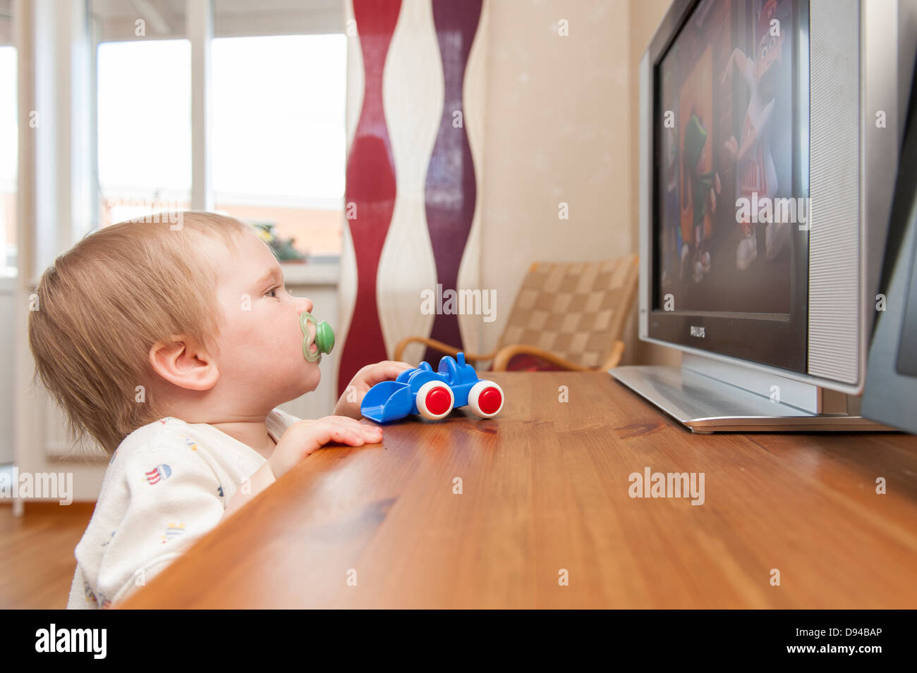 Boy watching TV at home Stock Photo - Alamy
