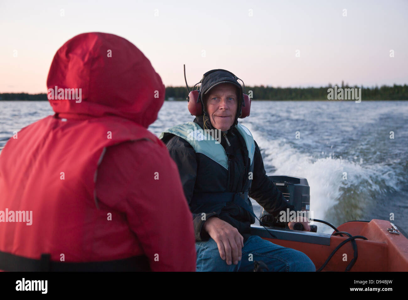 Man and woman on motorboat Stock Photo - Alamy