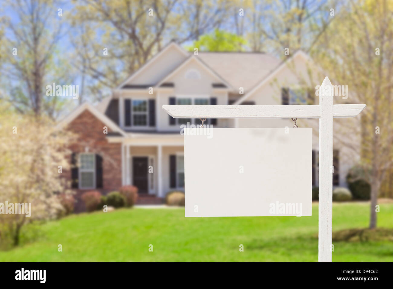 Blank Real Estate Sign in Front of Beautiful New House Stock Photo - Alamy