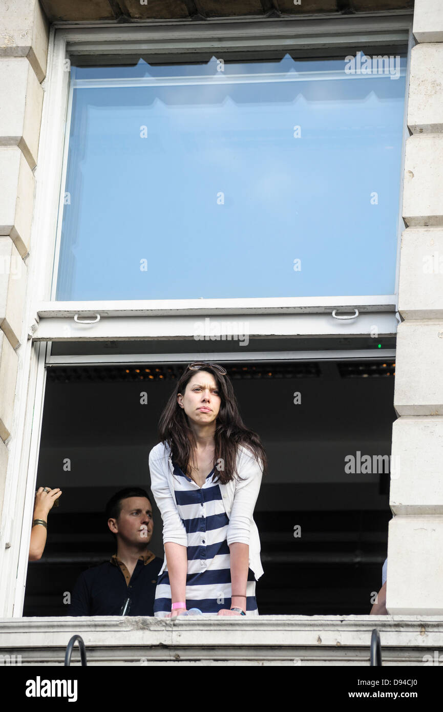 Young woman leaning out of a 1st floor window. Picture by Julie Edwards ...