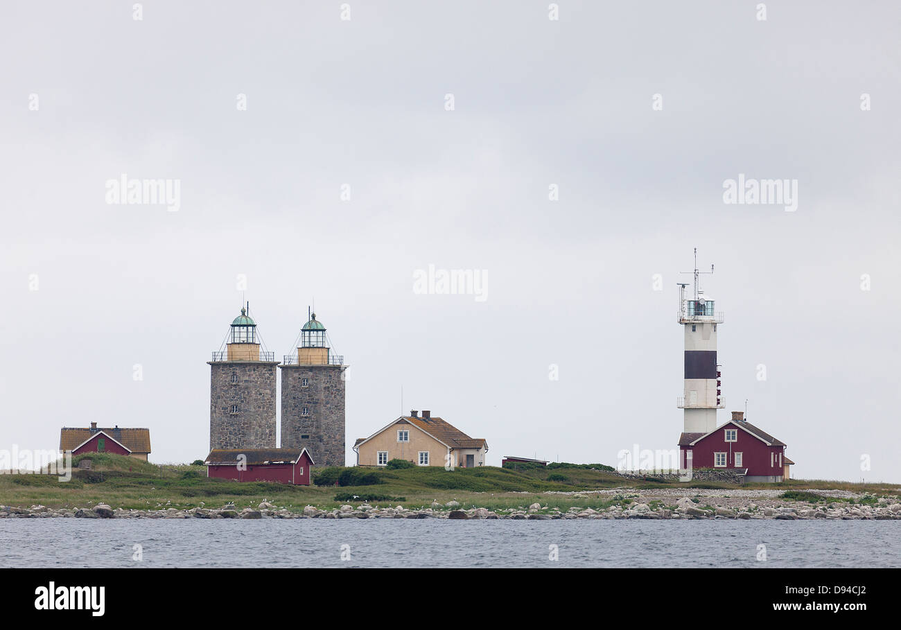 Lighthouse and buildings on coast Stock Photo - Alamy