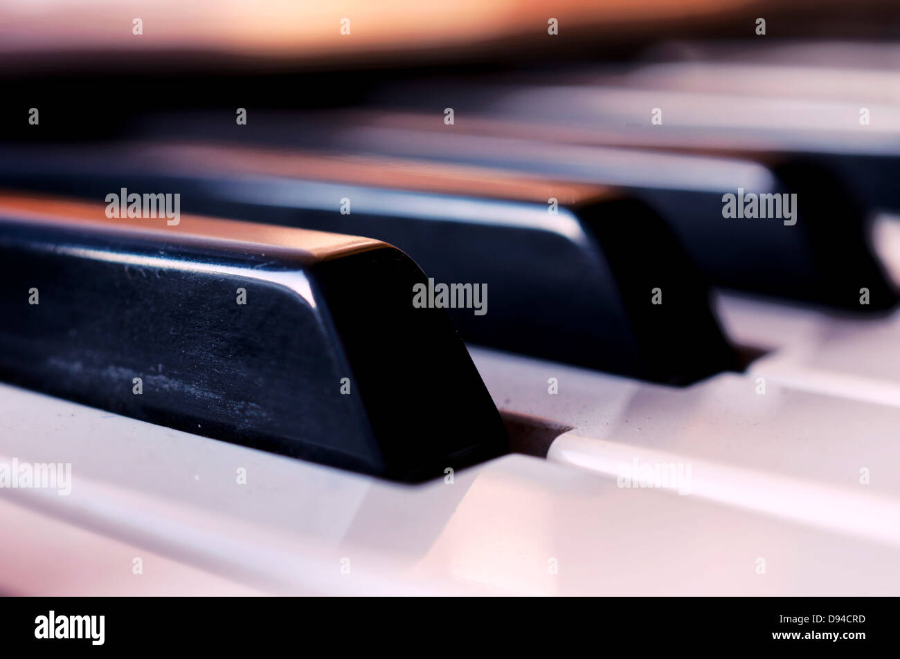 Close up to piano keyboard. Selective focus in middle of front piano ...