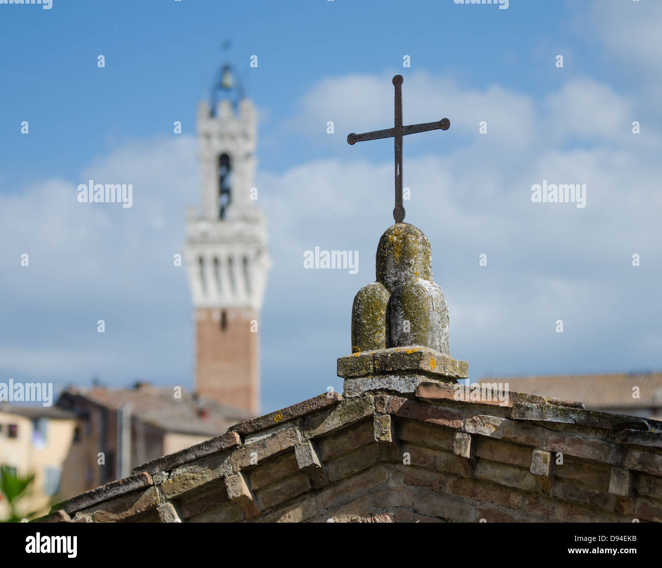a view of a cross on the roof of a small church opposite a blurred ...