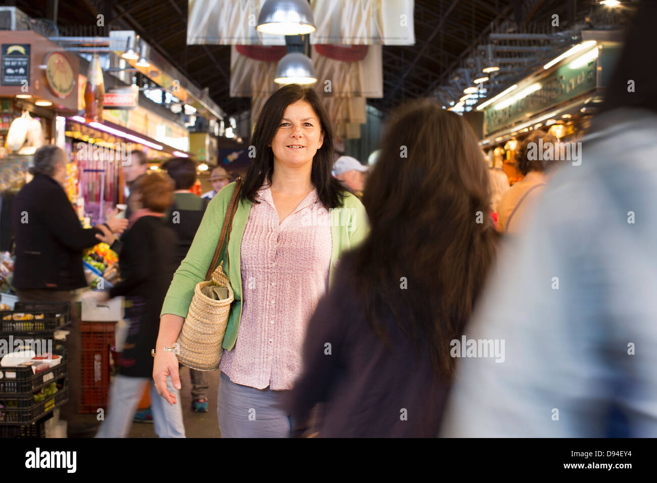 Woman walking through market in Barcelona Stock Photo - Alamy