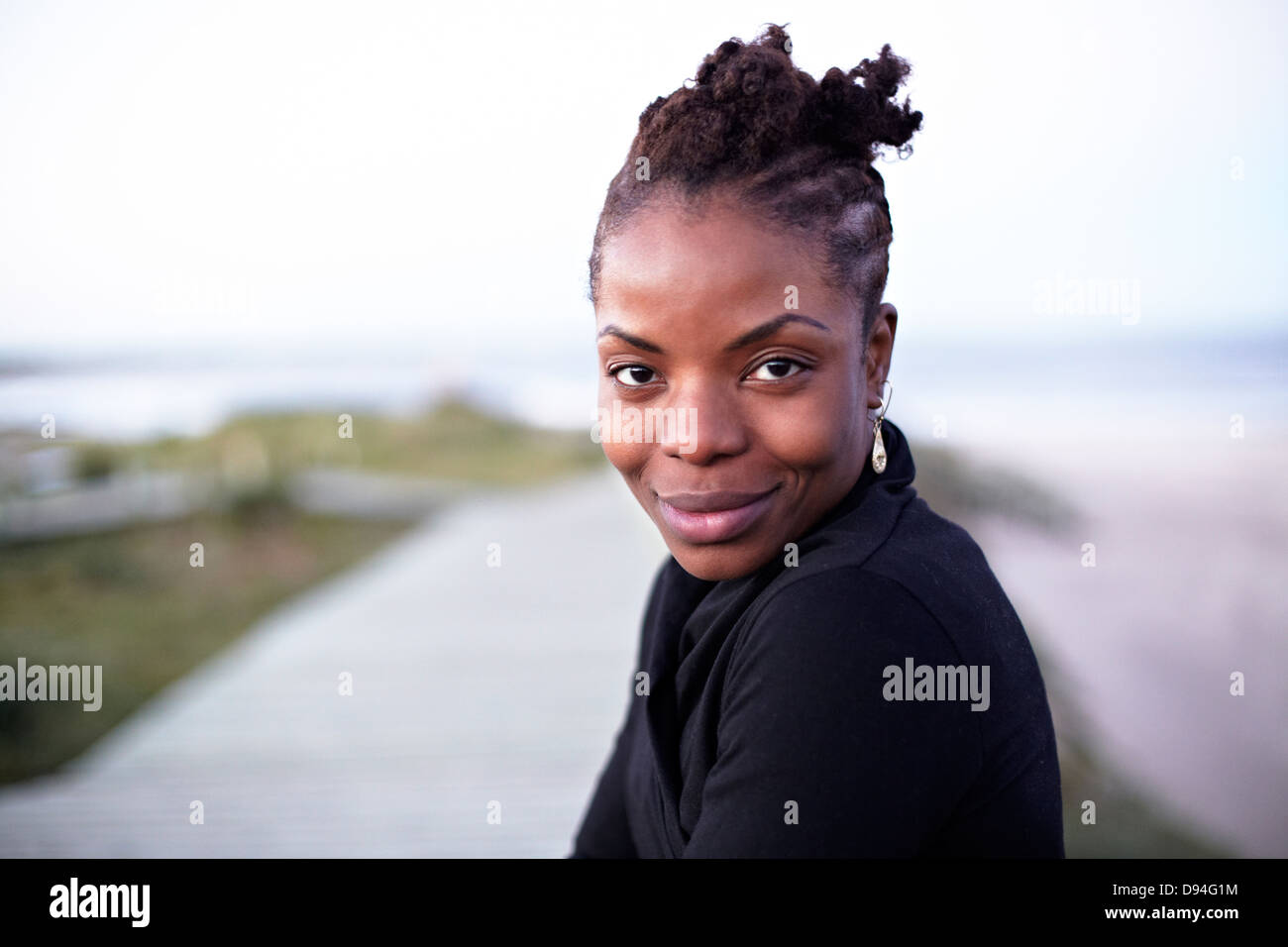Black woman smiling outdoors Stock Photo - Alamy