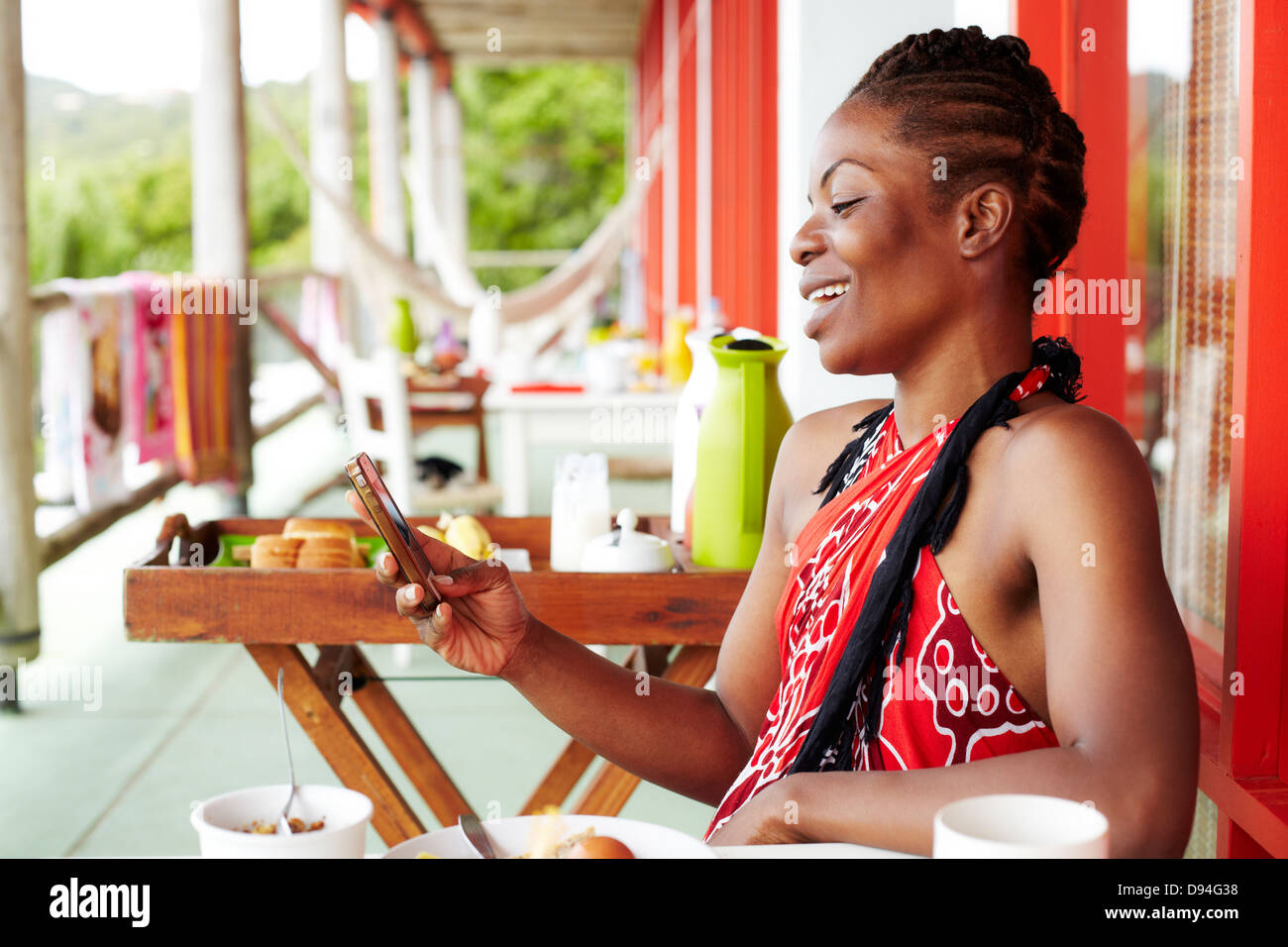 Black woman using cell phone at lunch Stock Photo - Alamy