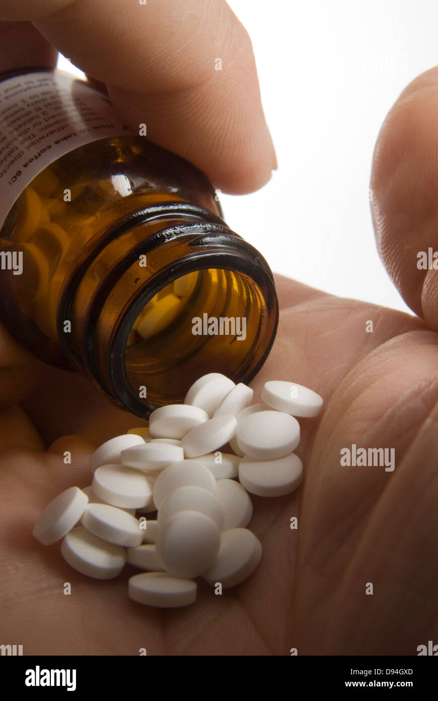 Homeopathic pills being poured into hand Stock Photo - Alamy