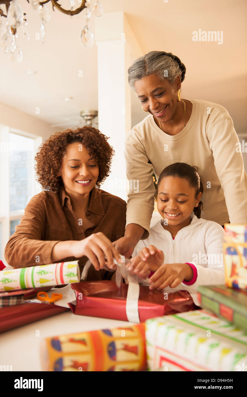 Three generations of women wrapping Christmas presents Stock Photo - Alamy