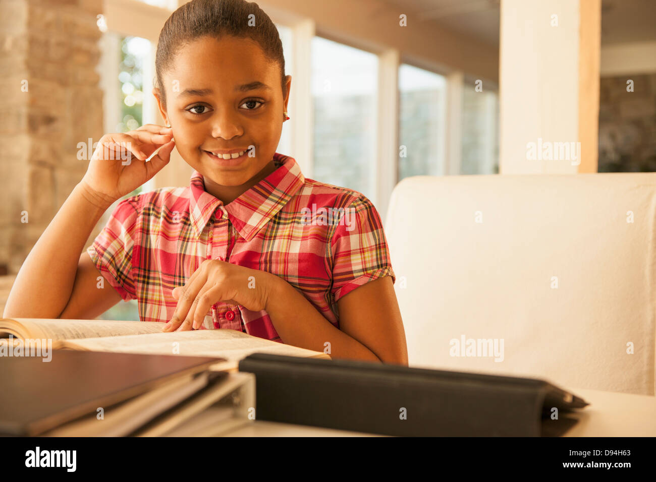 African American girl reading at table Stock Photo - Alamy