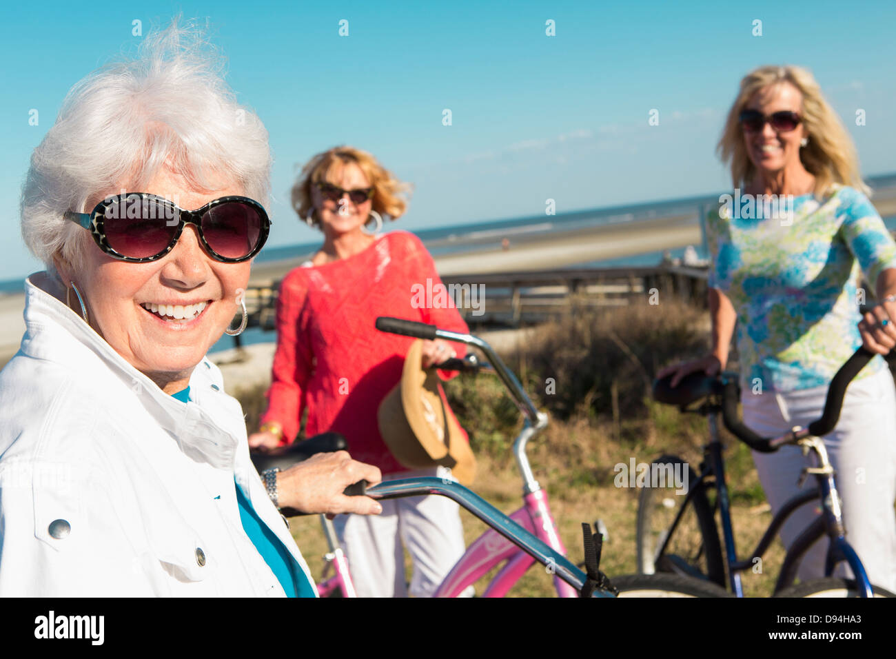 Caucasian women riding bicycles together Stock Photo - Alamy