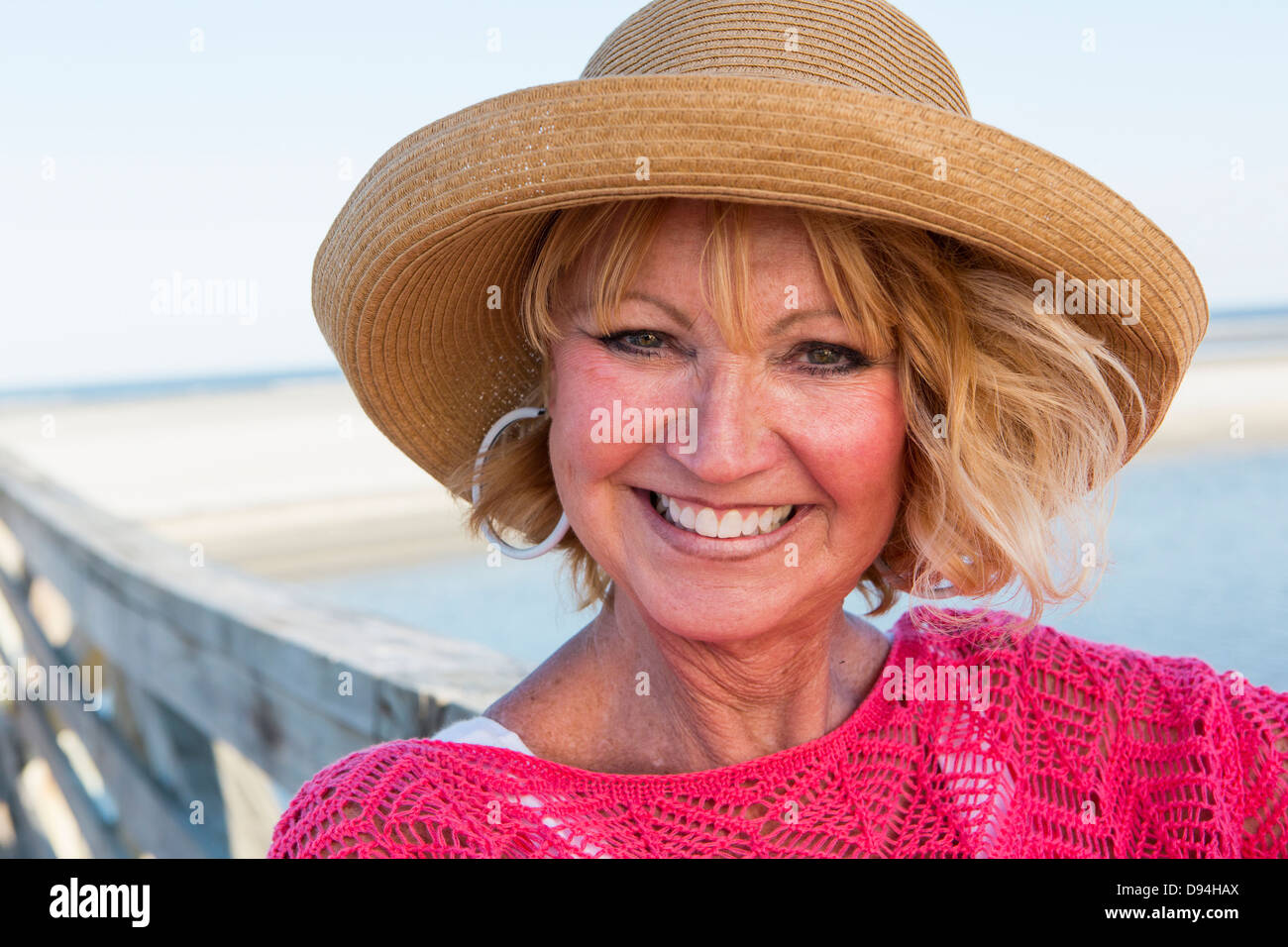 Caucasian woman smiling on beach Stock Photo - Alamy