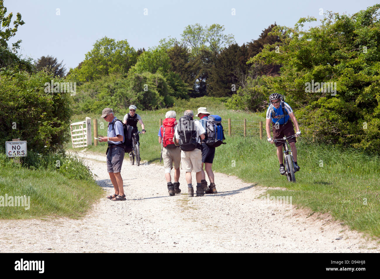 Walkers and cyclists on the South Downs Way at Bignor Hill, West Sussex ...