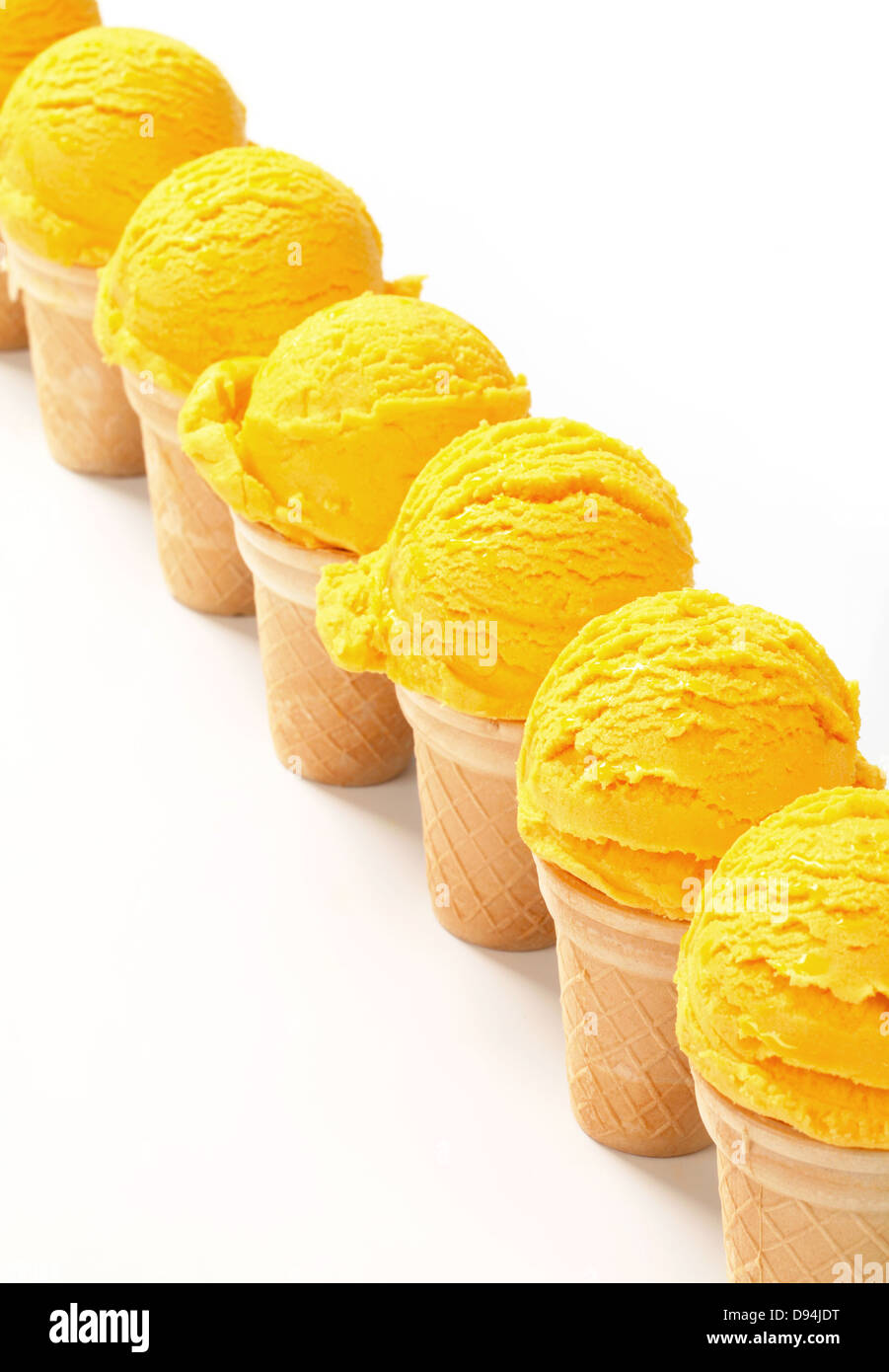 Yellow ice cream cones arranged in a row Stock Photo - Alamy