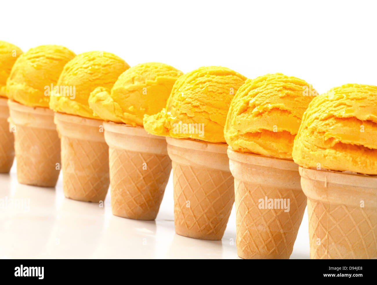 Yellow ice cream cones arranged in a row Stock Photo - Alamy