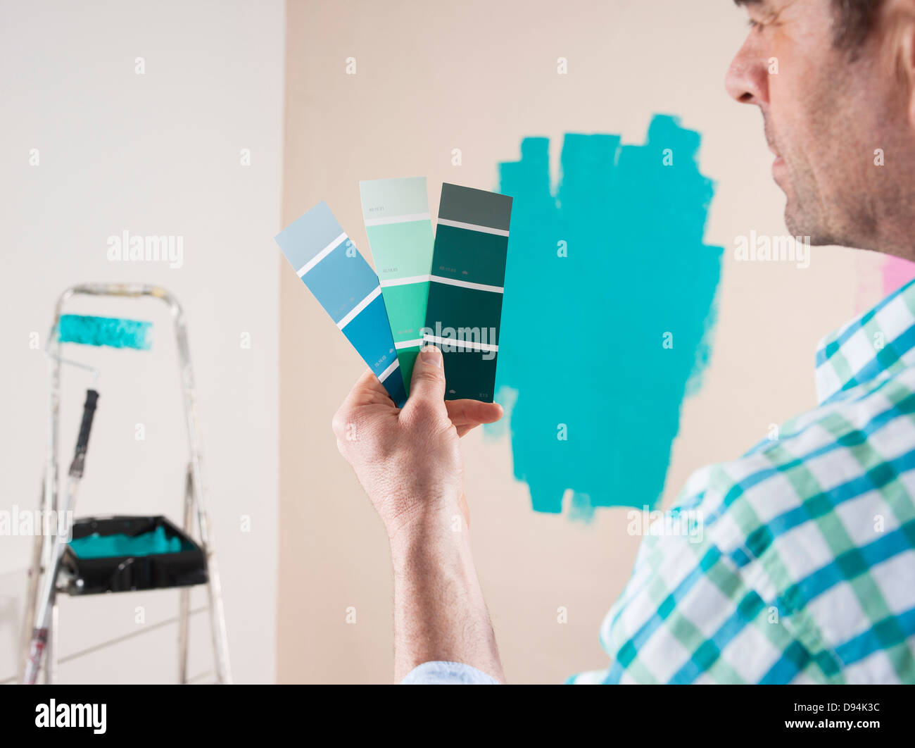 Over the Shoulder View of Mature Man Rrenovating his Home and Looking ...