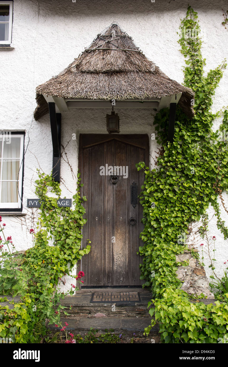 Ivy surrounding a thatched cob cottage door. Devon, England Stock Photo ...