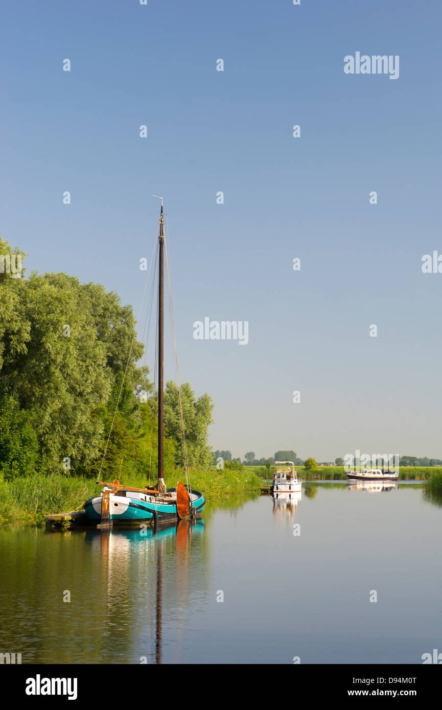 Dutch motorboats and vintage sailboat at the river Stock Photo - Alamy