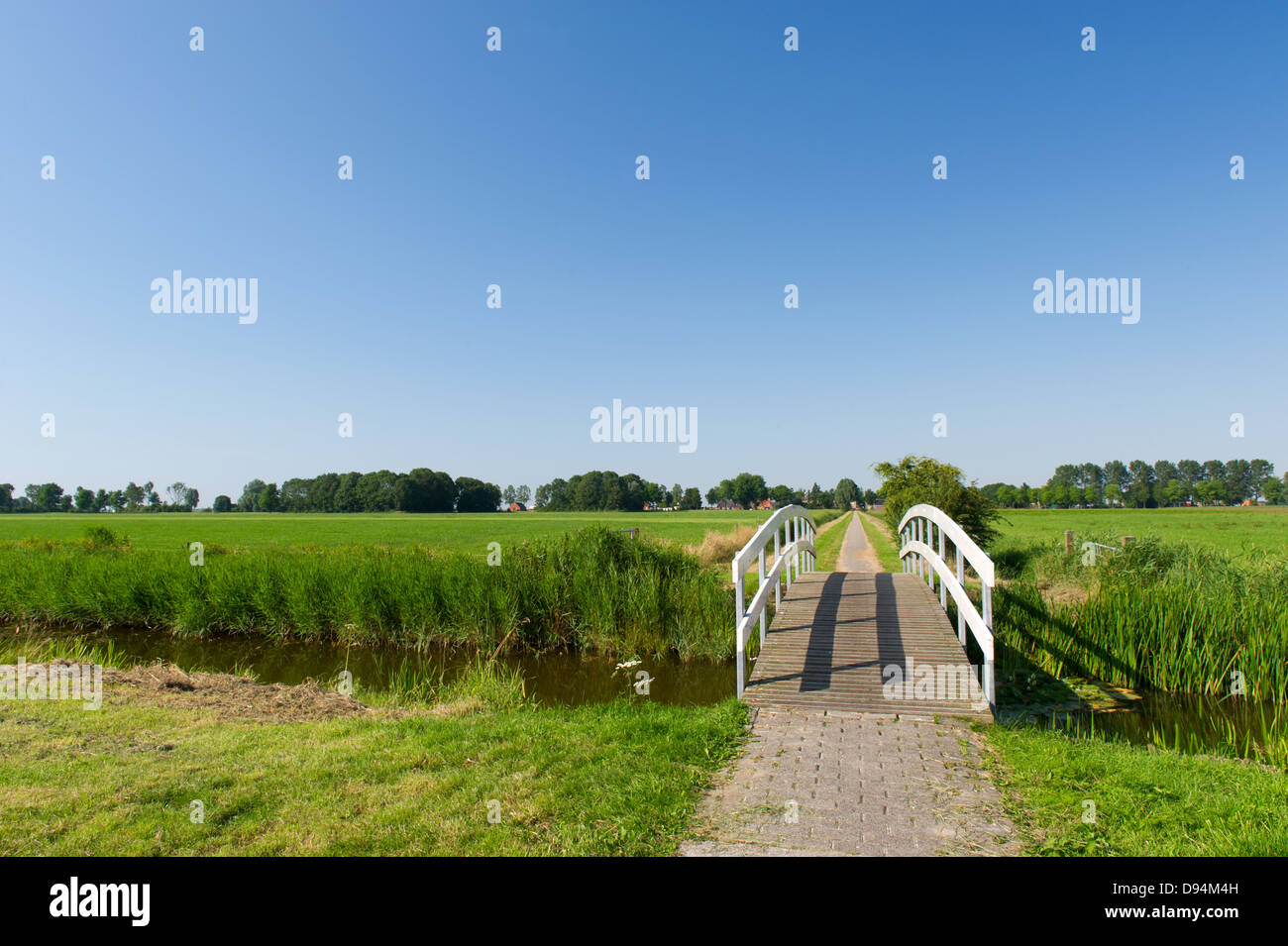 Small wooden white bridge in agricultural landscape Stock Photo - Alamy