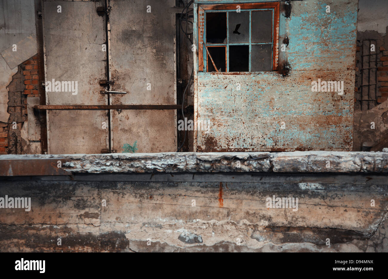 Abandoned factory with dirty doors and broken windows Stock Photo - Alamy