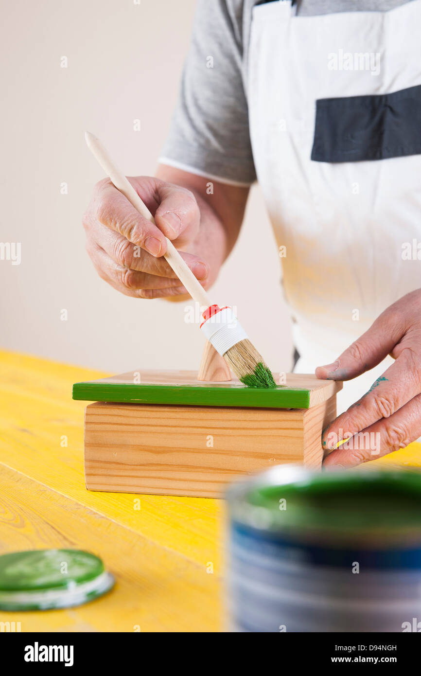 Man Painting Woodworking Project in Studio Stock Photo - Alamy