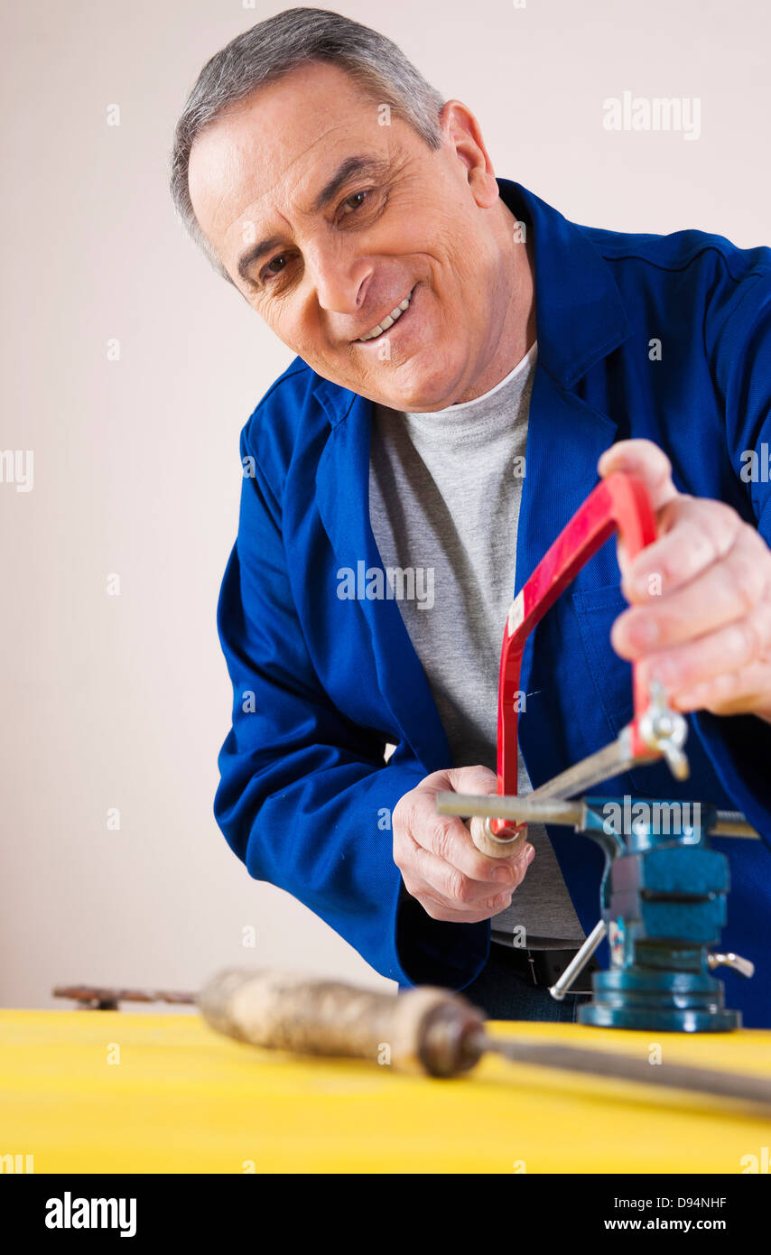Man Cutting a Pipe for a Plumbing Project, in Studio Stock Photo - Alamy