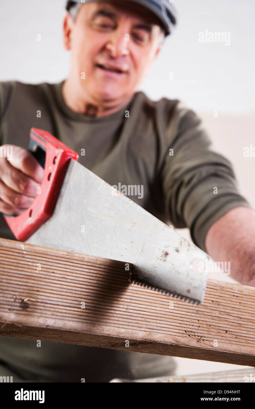 Man Cutting Lumber, Woodworking Project, in Studio Stock Photo - Alamy