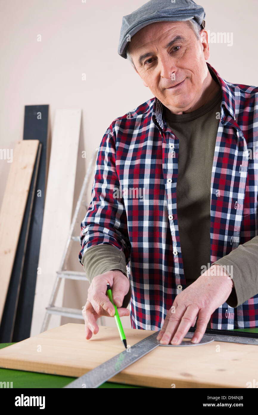 Man Measuring Lumber, Woodworking Project, in Studio Stock Photo - Alamy