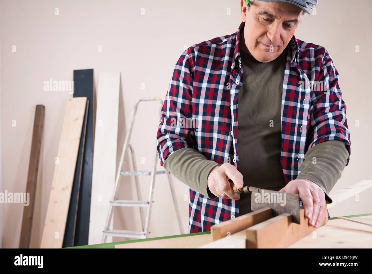 Man Cutting Lumber, Woodworking Project, in Studio Stock Photo - Alamy