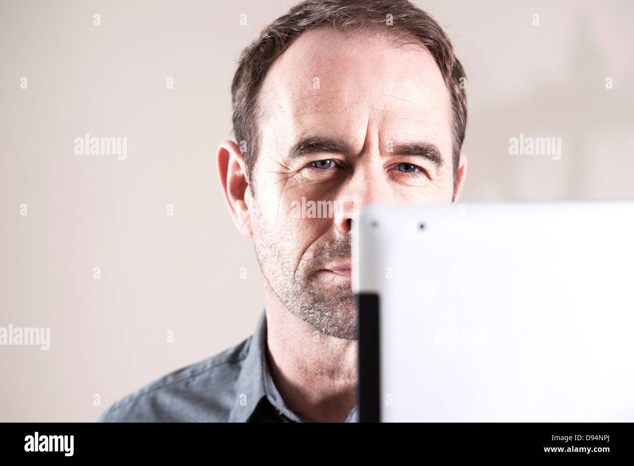 Businessman Looking at Tablet Computer, Studio Shot Stock Photo - Alamy