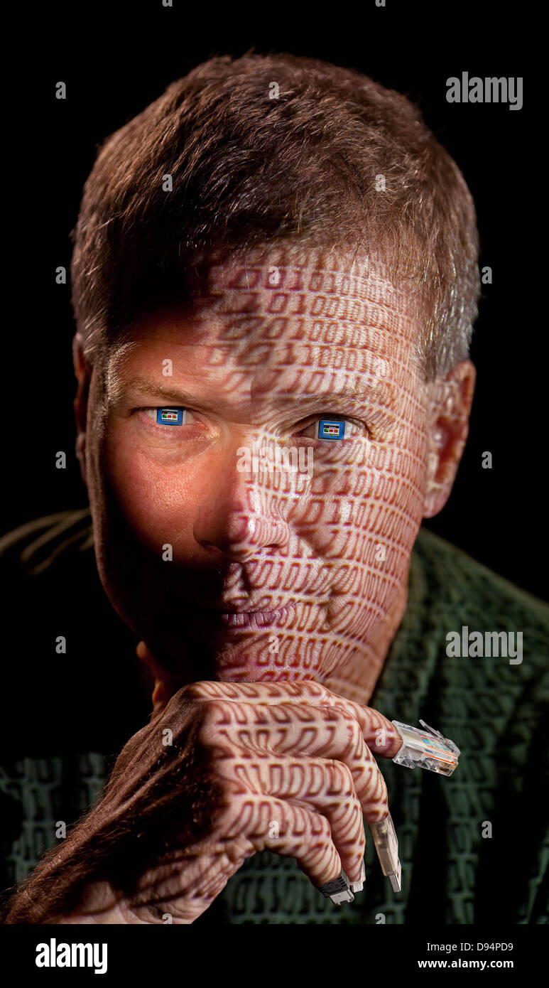 Computer Man with computer code projected on face and cables attached ...